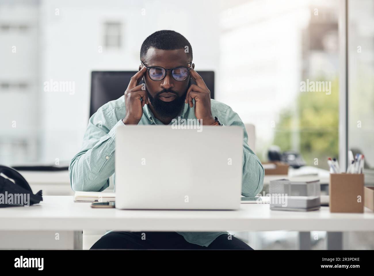 Thinking, computer and business man in office planning, brainstorming ...
