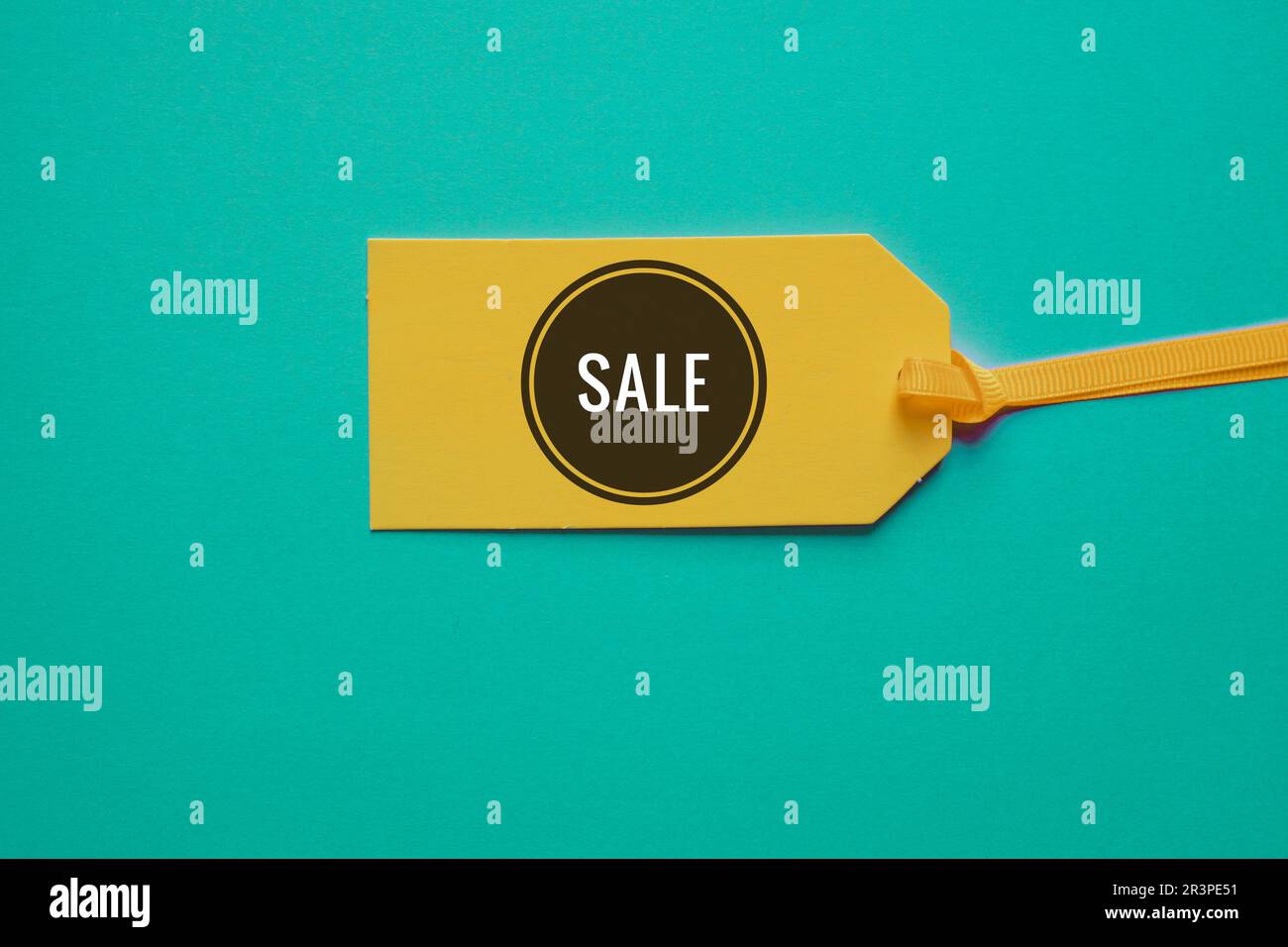 sale word on the yellow price tag for sales Stock Photo - Alamy