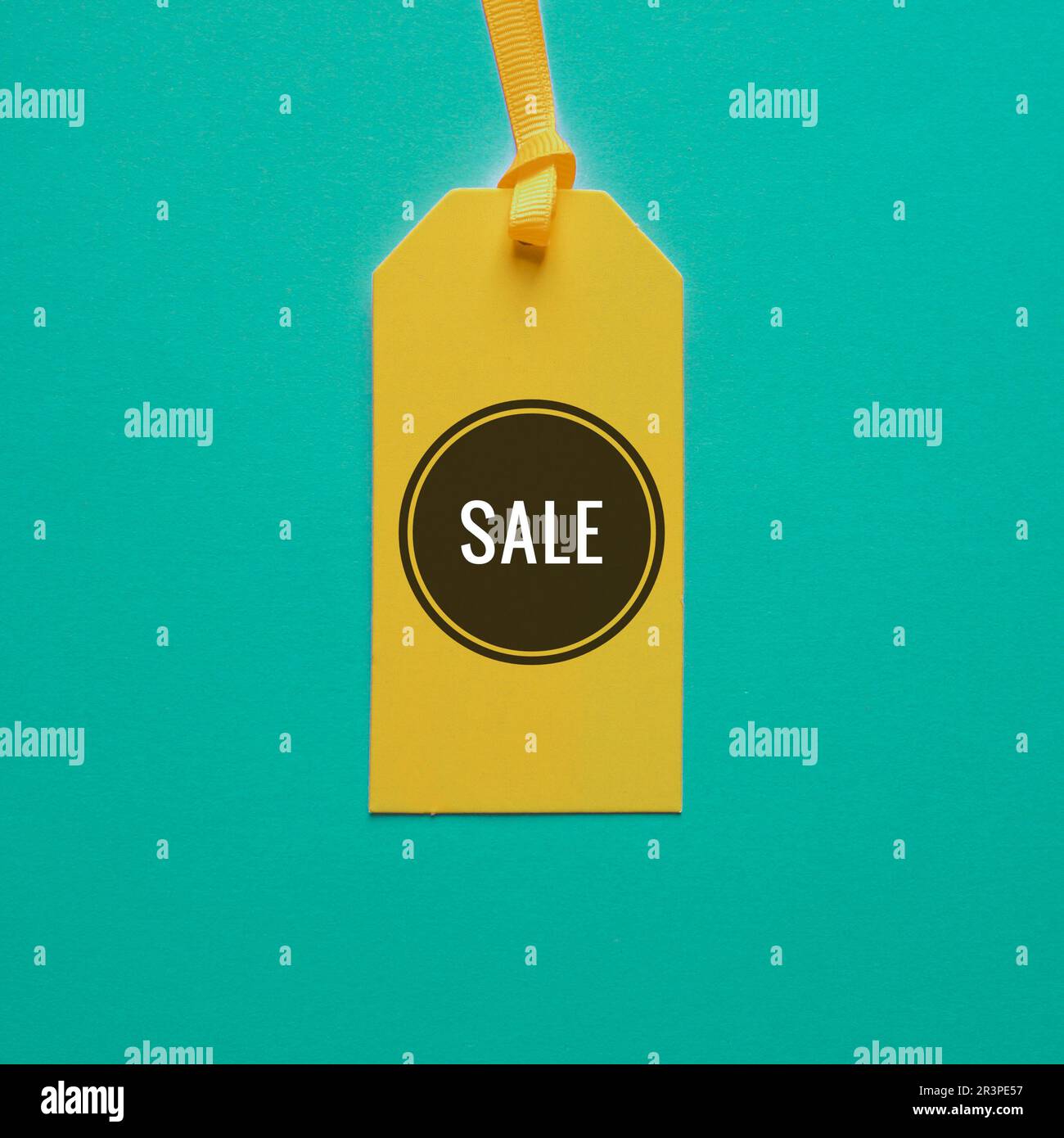 sale word on the yellow price tag for sales Stock Photo - Alamy