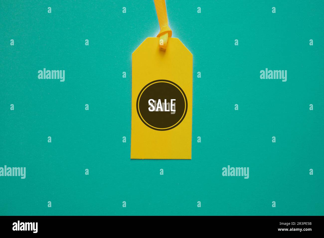 sale word on the yellow price tag for sales Stock Photo - Alamy