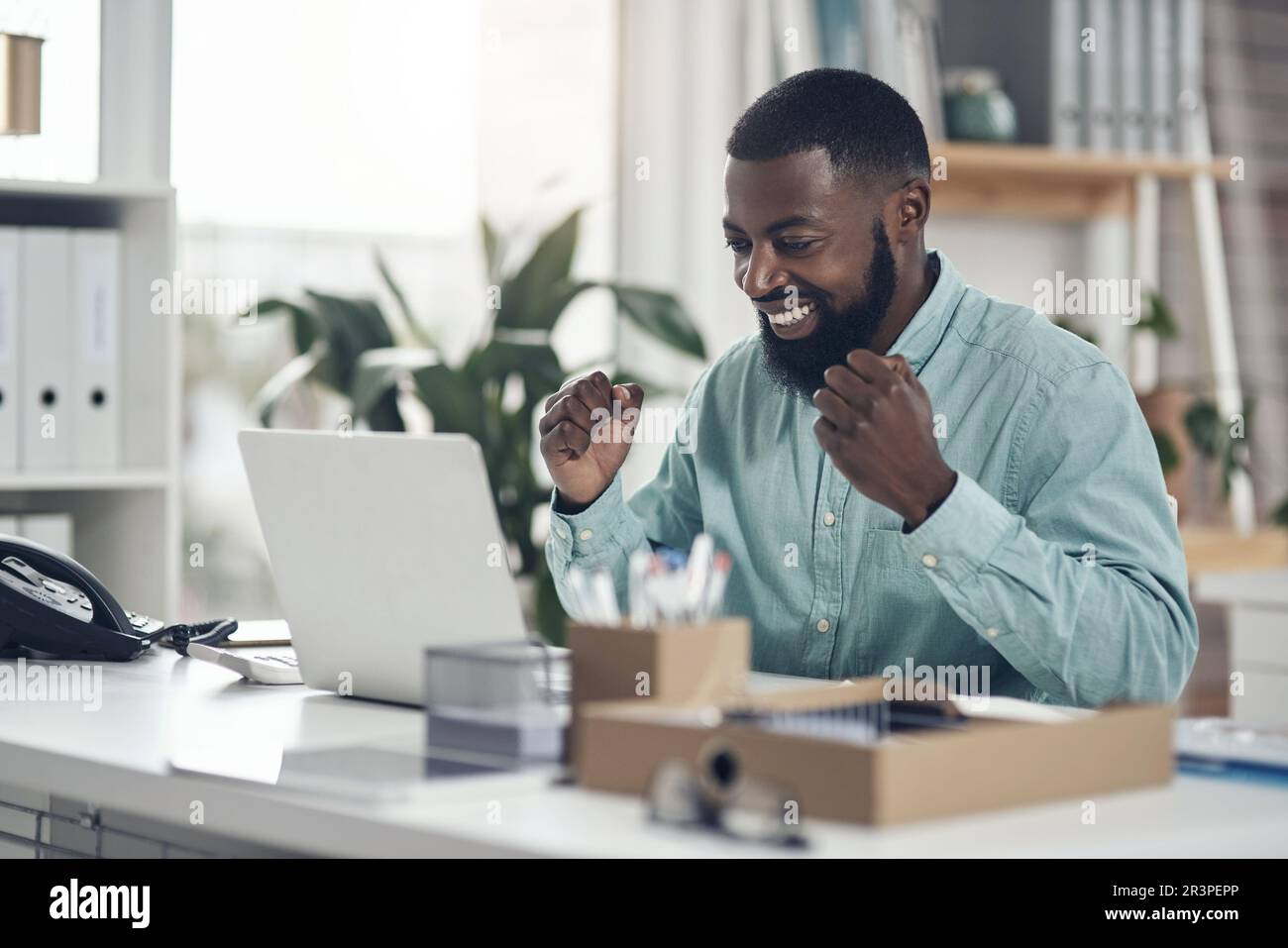 Black man, success and laptop to celebrate business profit, win or ...