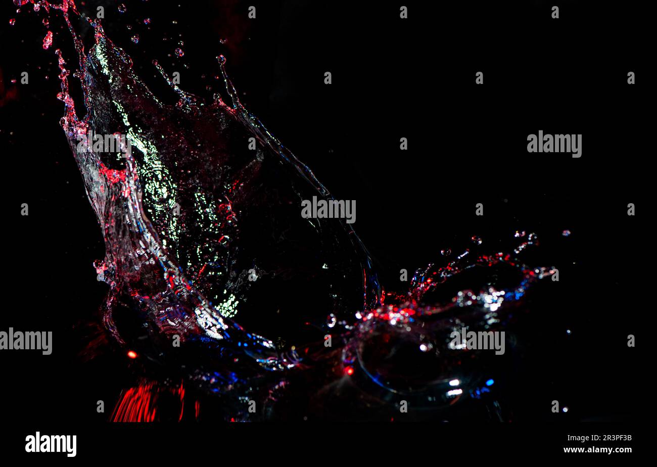 colorful splash of water on black background Stock Photo - Alamy