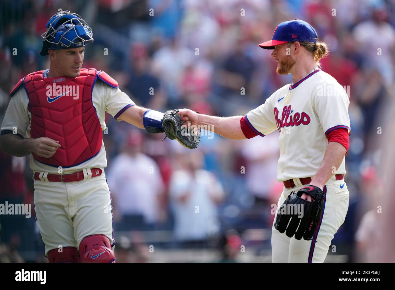 Philadelphia Phillies' J.T. Realmuto, left, and Craig Kimbrel react ...