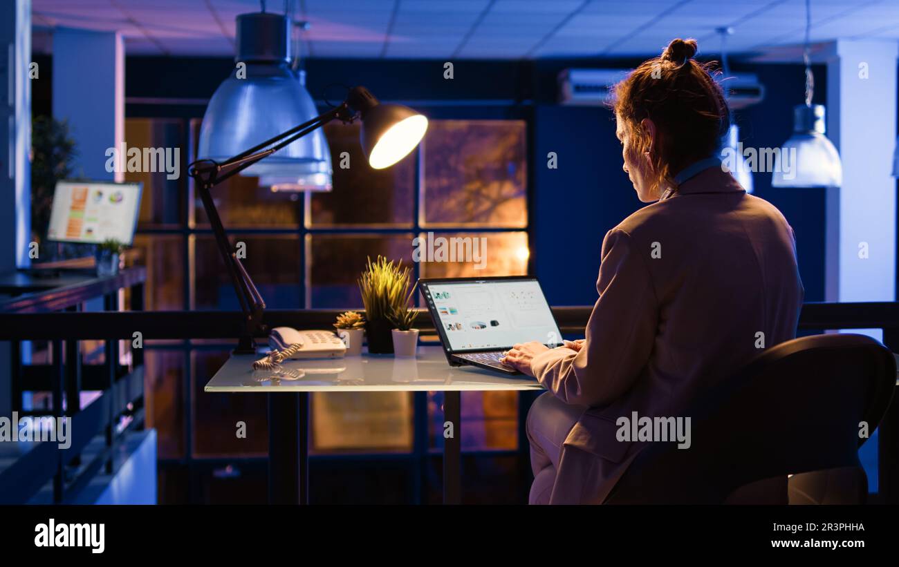 Caucasian woman planning business project at night Stock Photo - Alamy