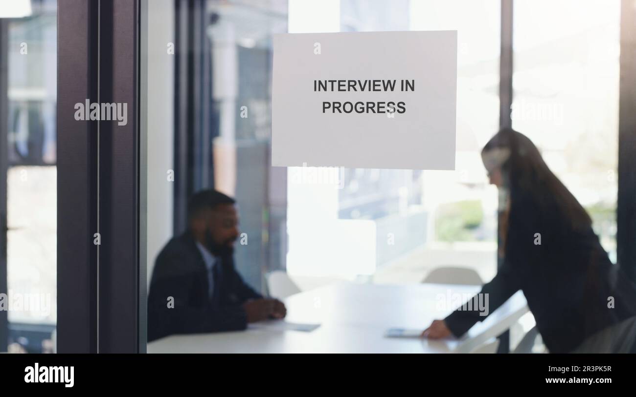 Recruitment, window sign and business people in an interview in the ...