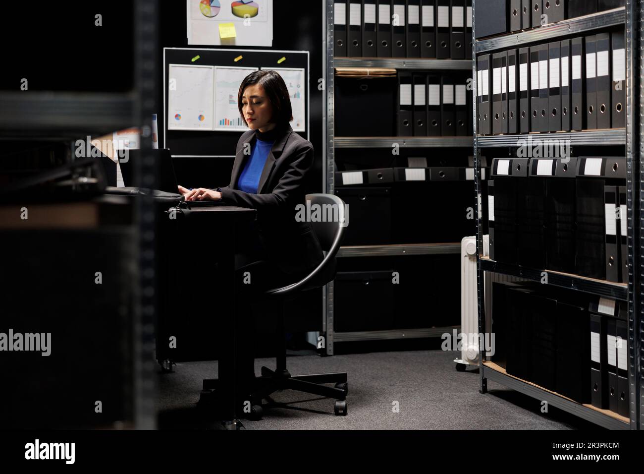 Asian detective checking evidence files Stock Photo - Alamy