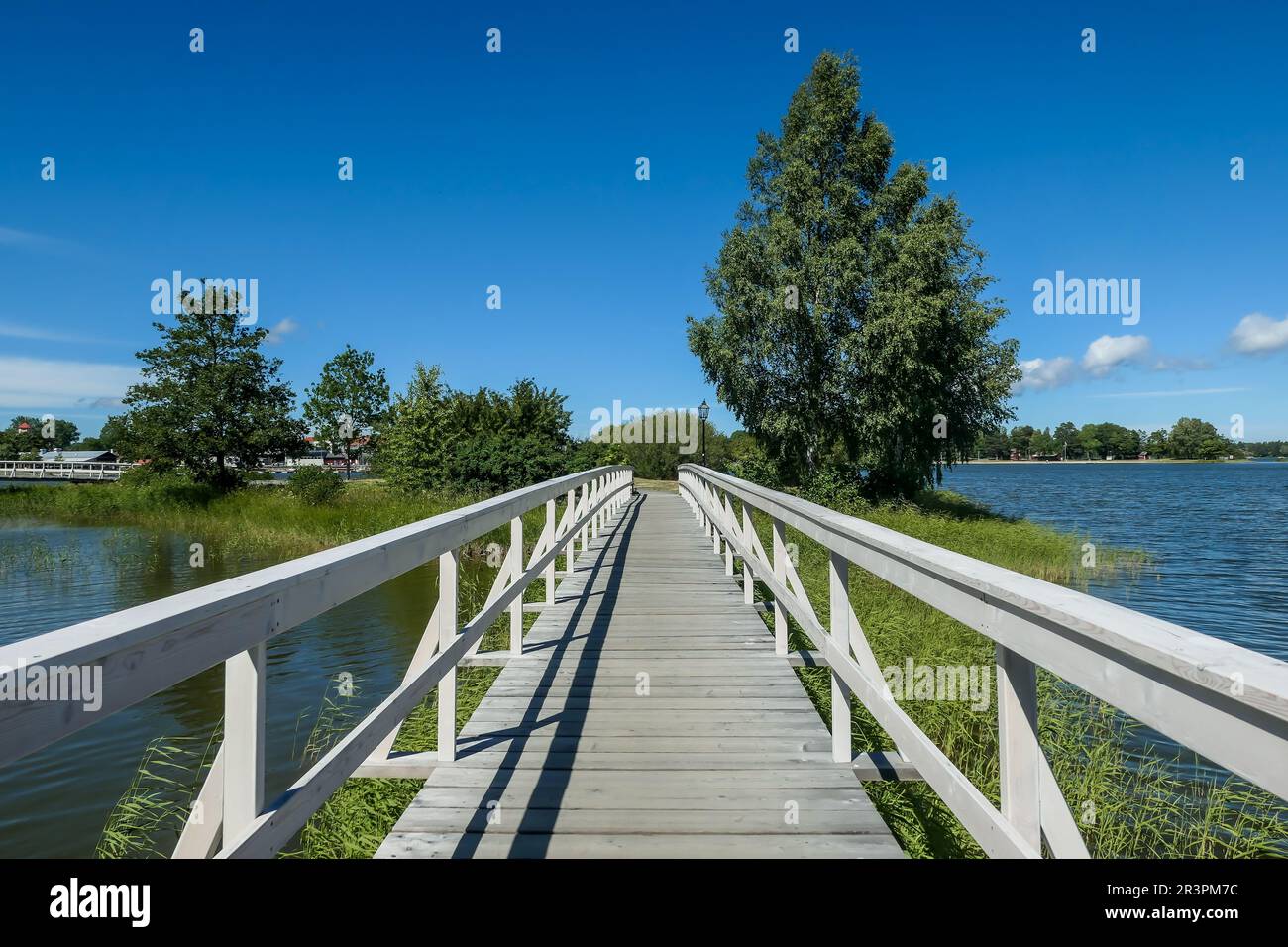 a white wooden bridge over the water Stock Photo - Alamy