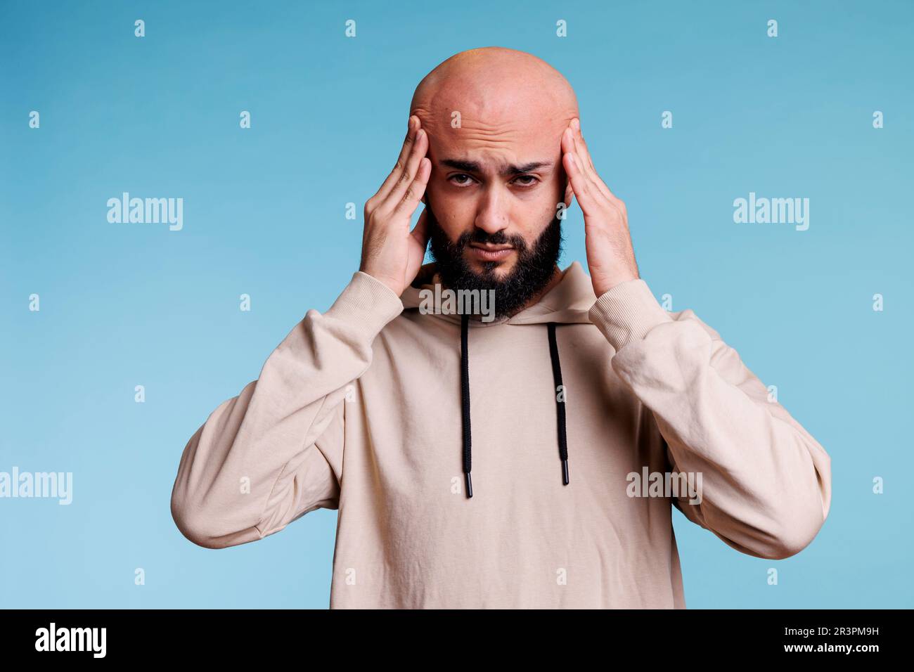 Arab man feeling tension in temples Stock Photo - Alamy