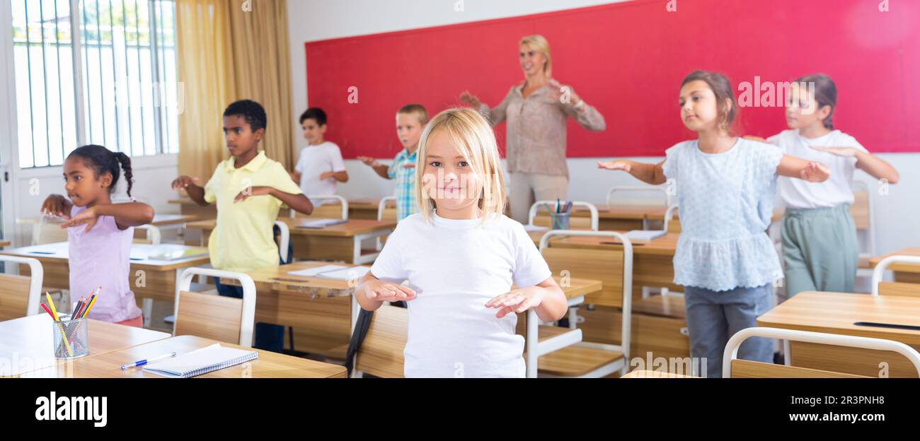 Kids pupils having physical training between lessons Stock Photo - Alamy