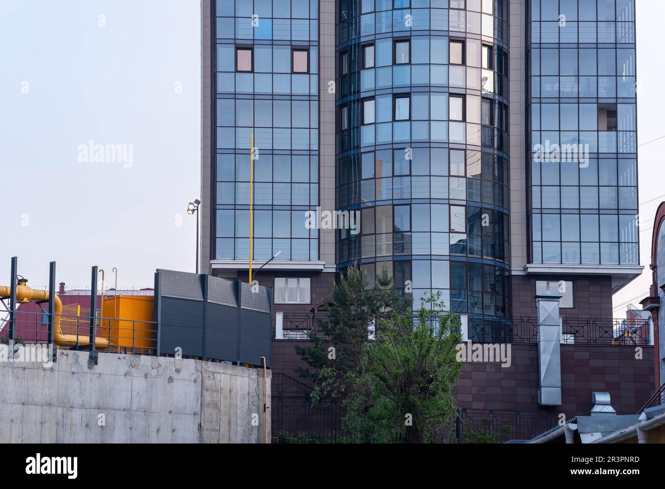 urban background, cityscape with a glass facade of a tall building ...