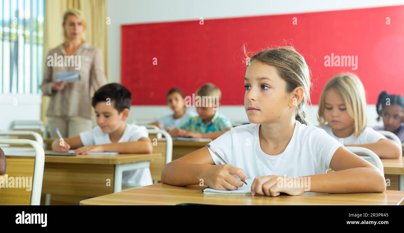 School girl working at lesson in classroom Stock Photo - Alamy
