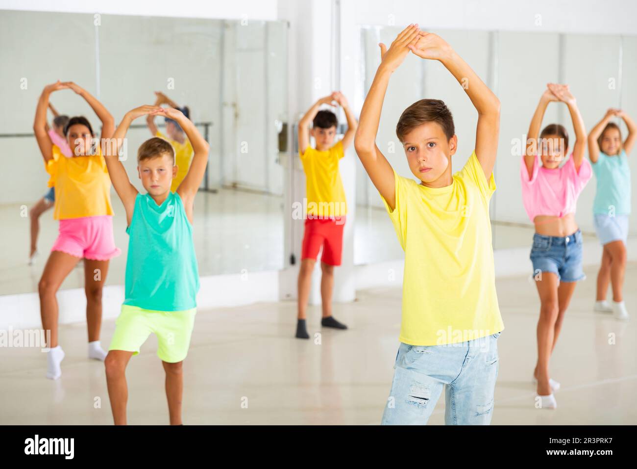 Group of kids training dance moves Stock Photo - Alamy