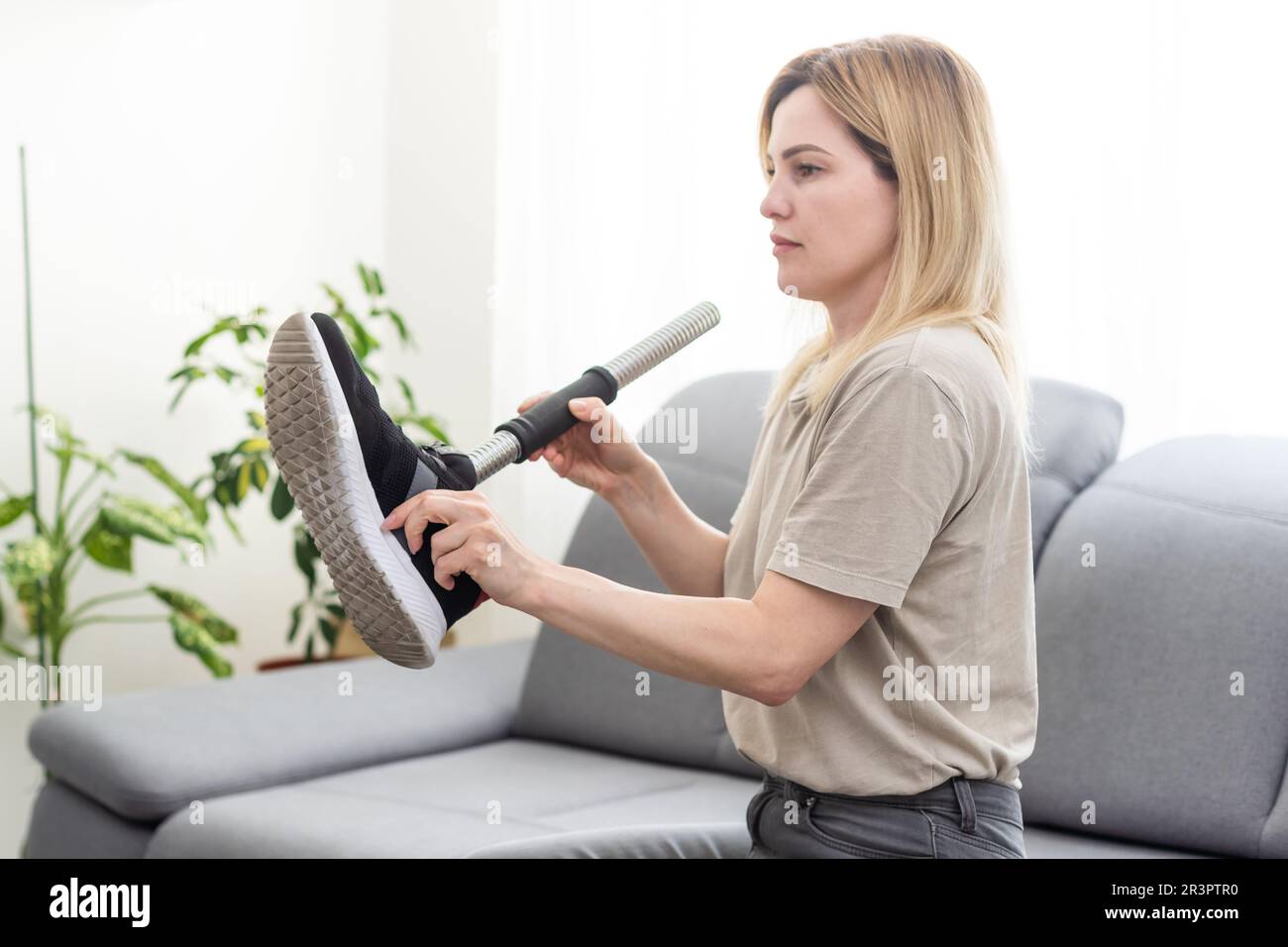 Female technician assembling and fixing parts of modern prosthetic leg ...