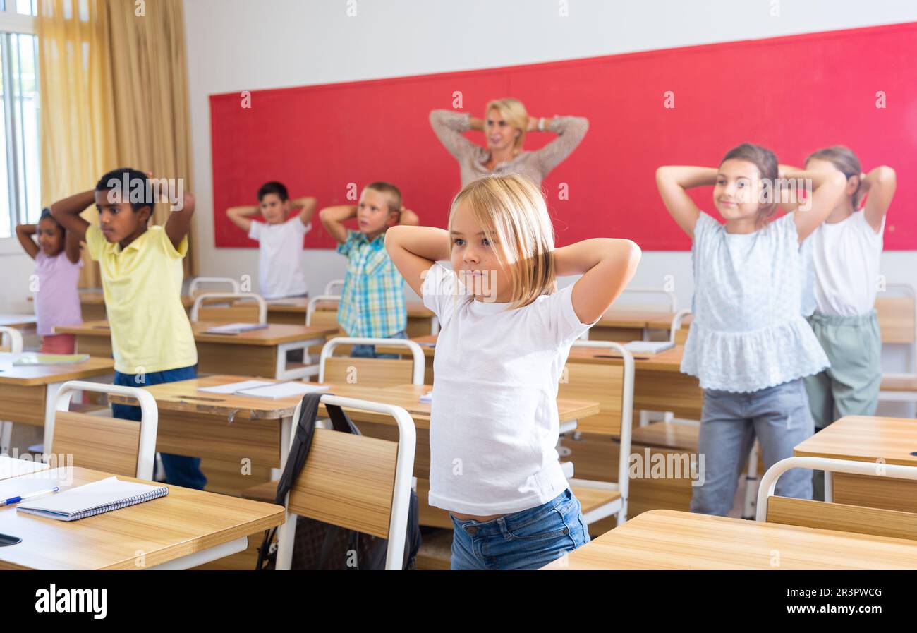 Tweens with female teacher during physical activity break Stock Photo ...