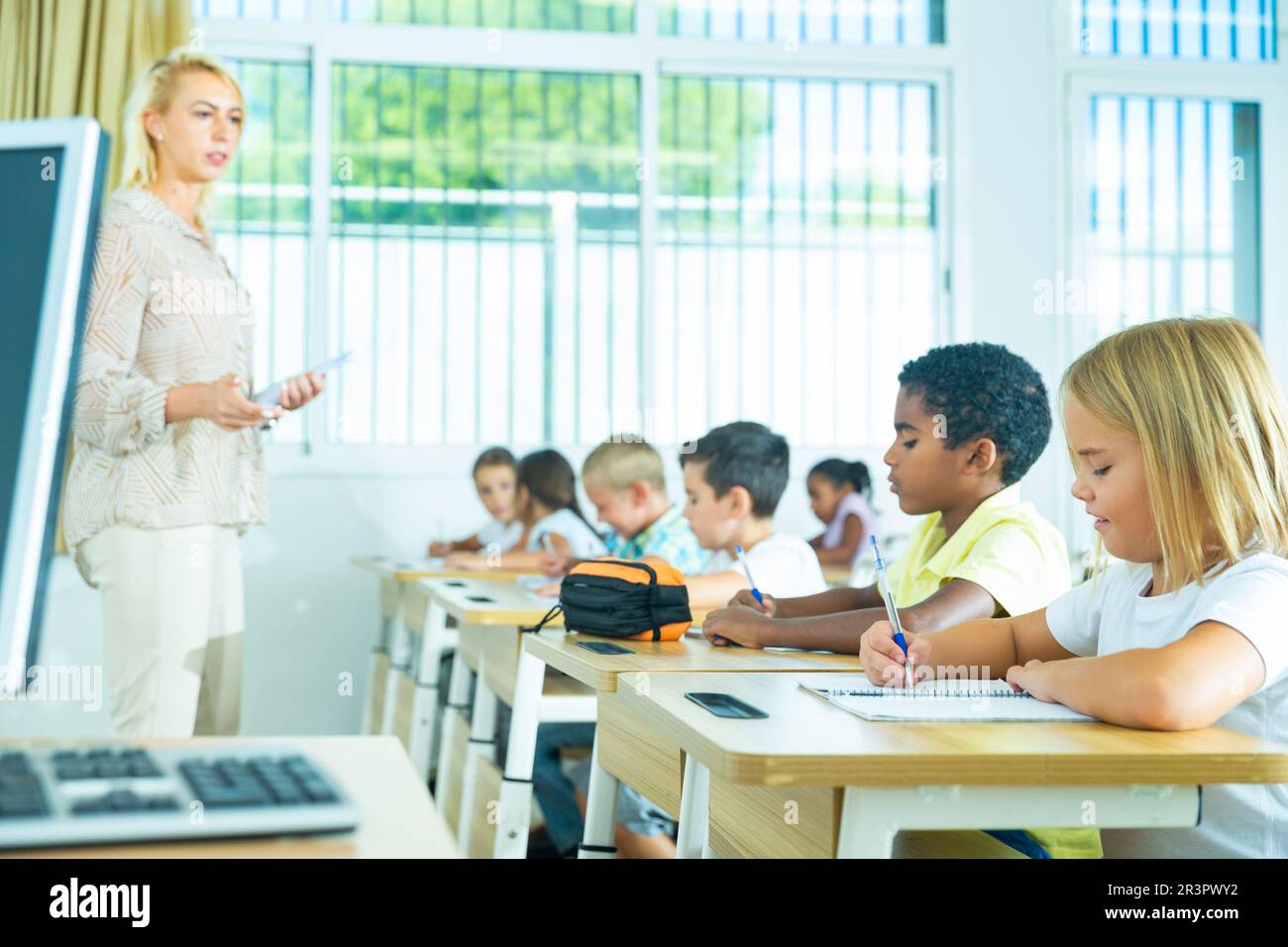Side view of schoolkids group working on lecture in classroom Stock ...