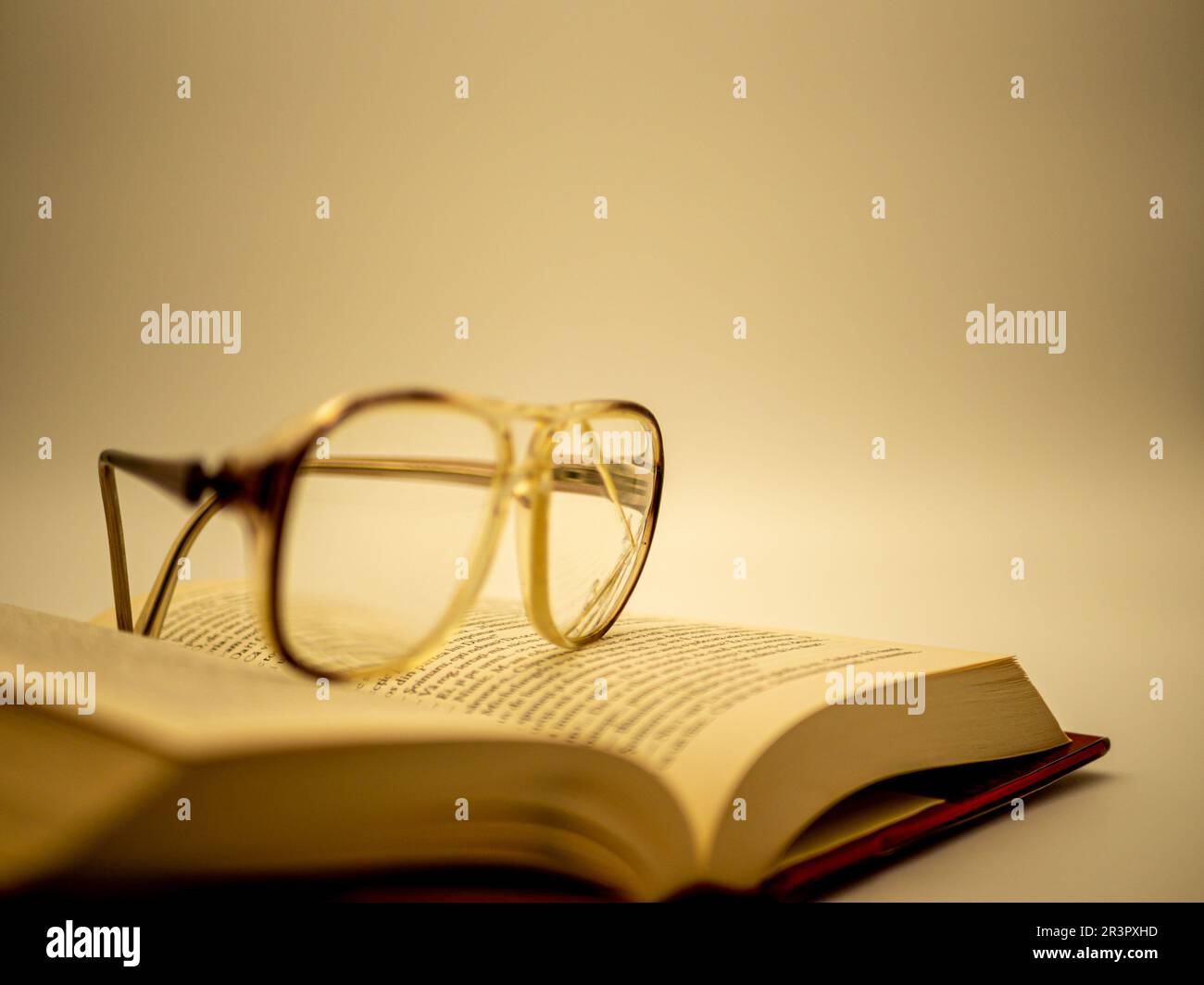 cracked eyeglasses resting on a open book vintage look photo Stock ...