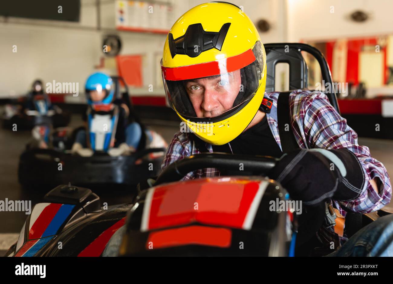 Portrait of glad man driving racing car Stock Photo - Alamy