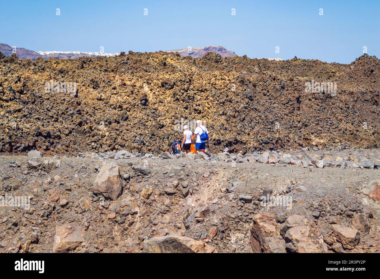 Tourists hiking to the active volcano- highlight of Santorini and ...