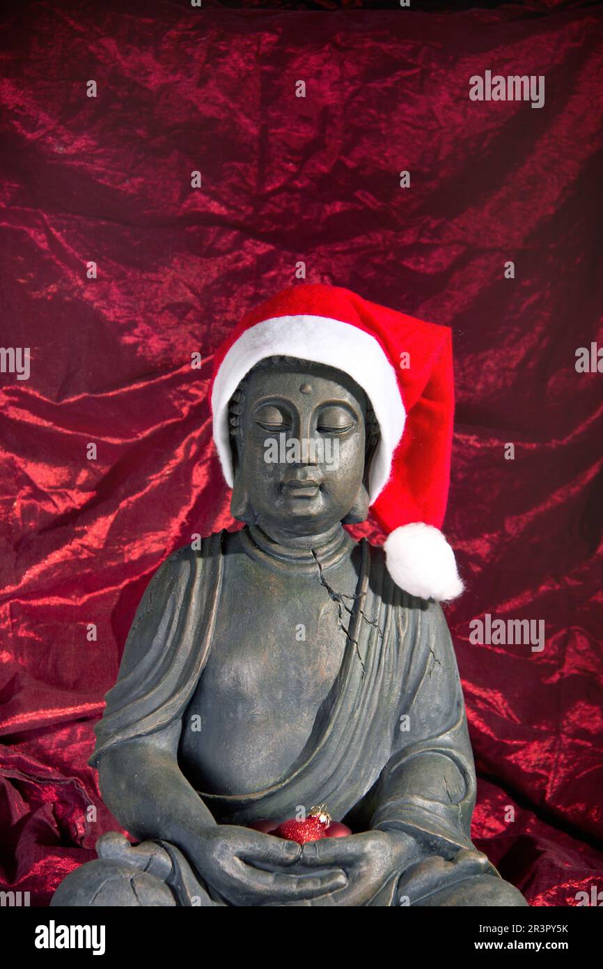 buddha statue with Santa Claus cap and Christmas decorations Stock ...