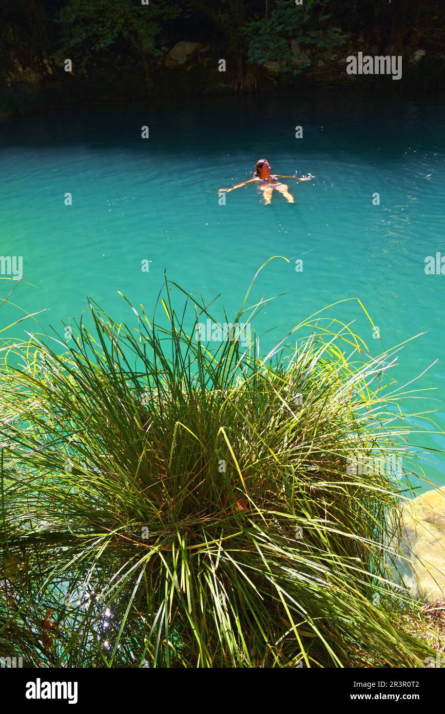 woman swimming in the lake of the waterfalls of Polylimnio, Greece ...