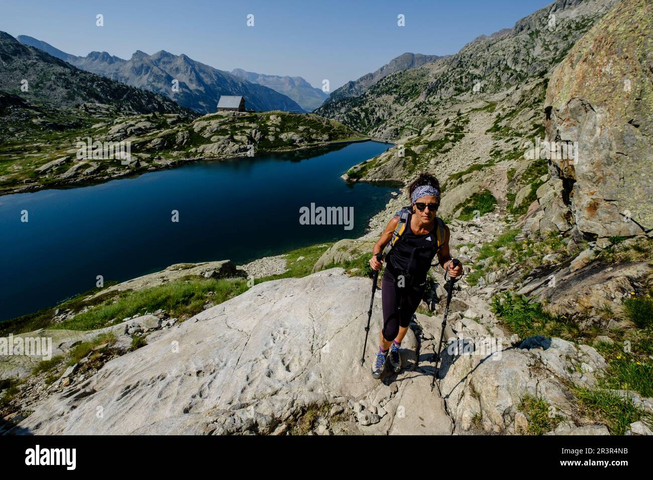 hiker on Bachimaña reservoir, Ibones azules and Bachimaña alto route ...