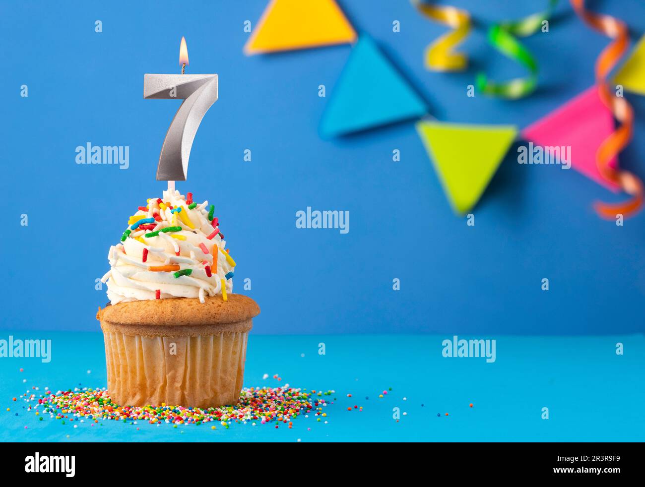 Birthday cake with candle number 7 - Blue background Stock Photo - Alamy