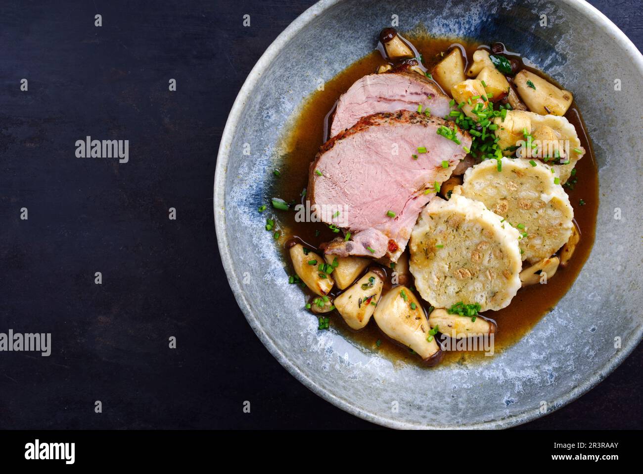 Traditional German pork roast served with bread dumpling and king ...