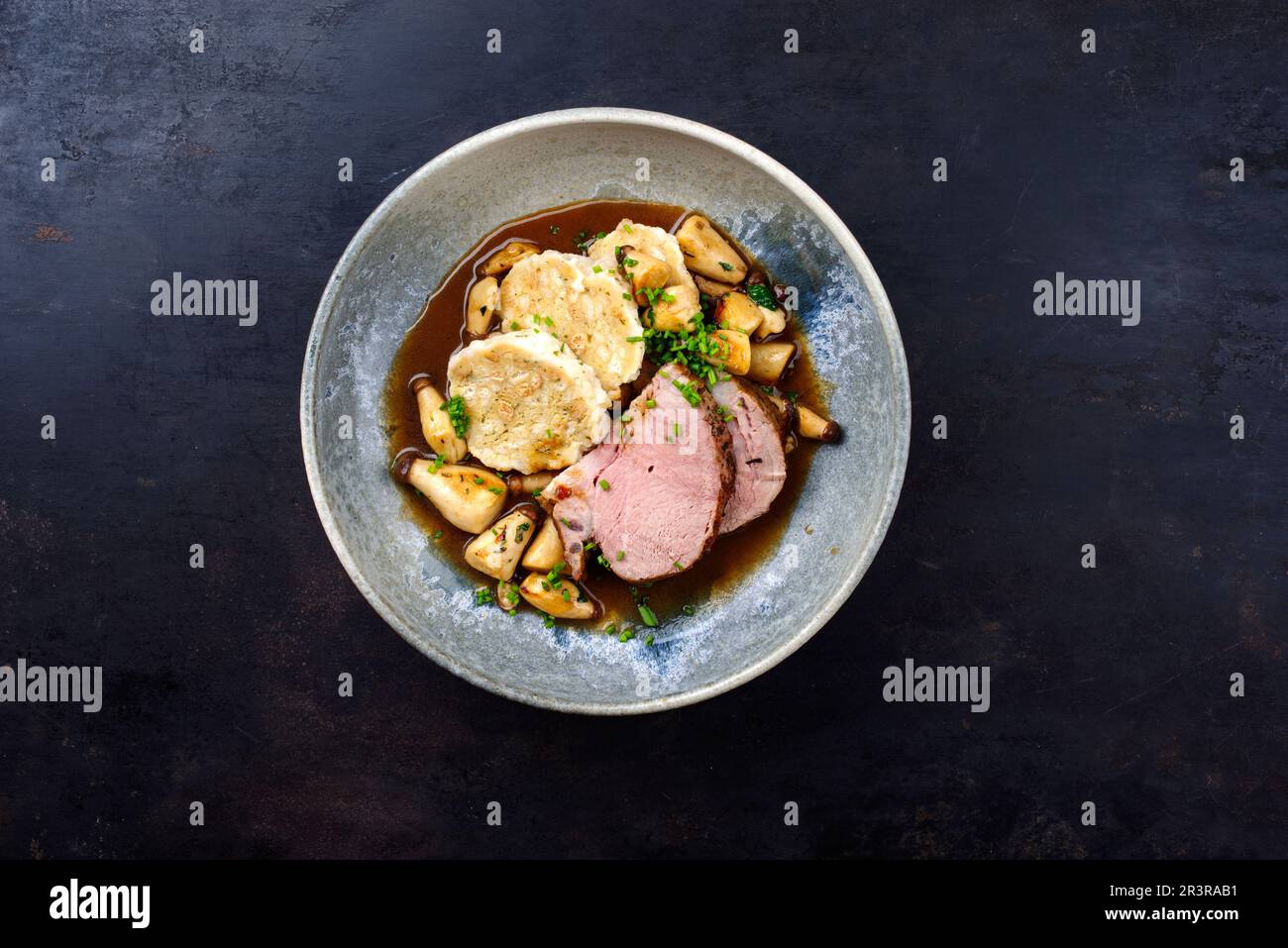 Traditional German pork roast served with bread dumpling and king ...