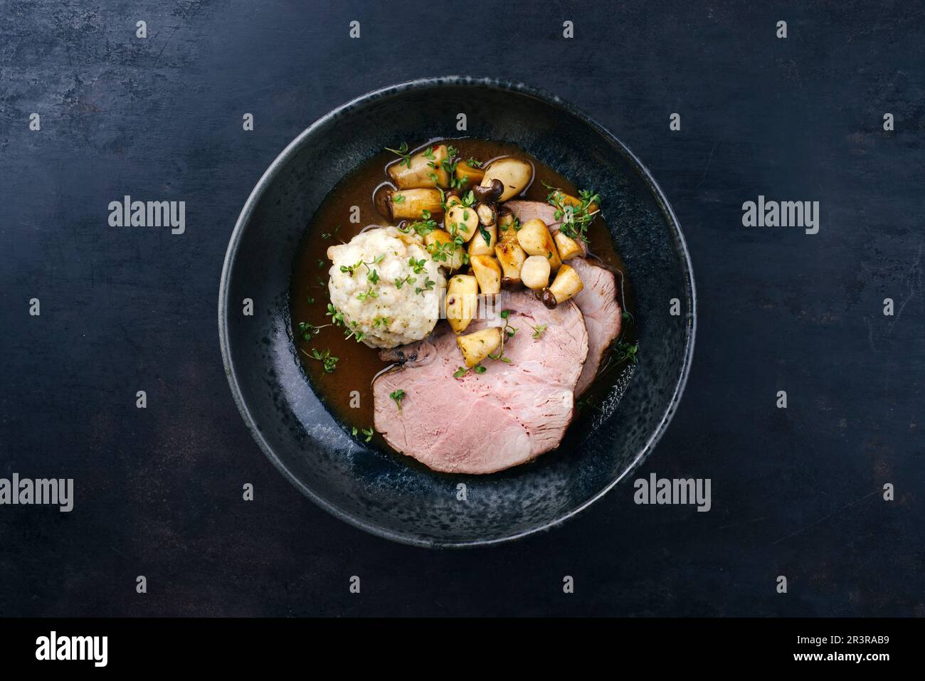 Traditional German pork roast served with bread dumpling and king ...