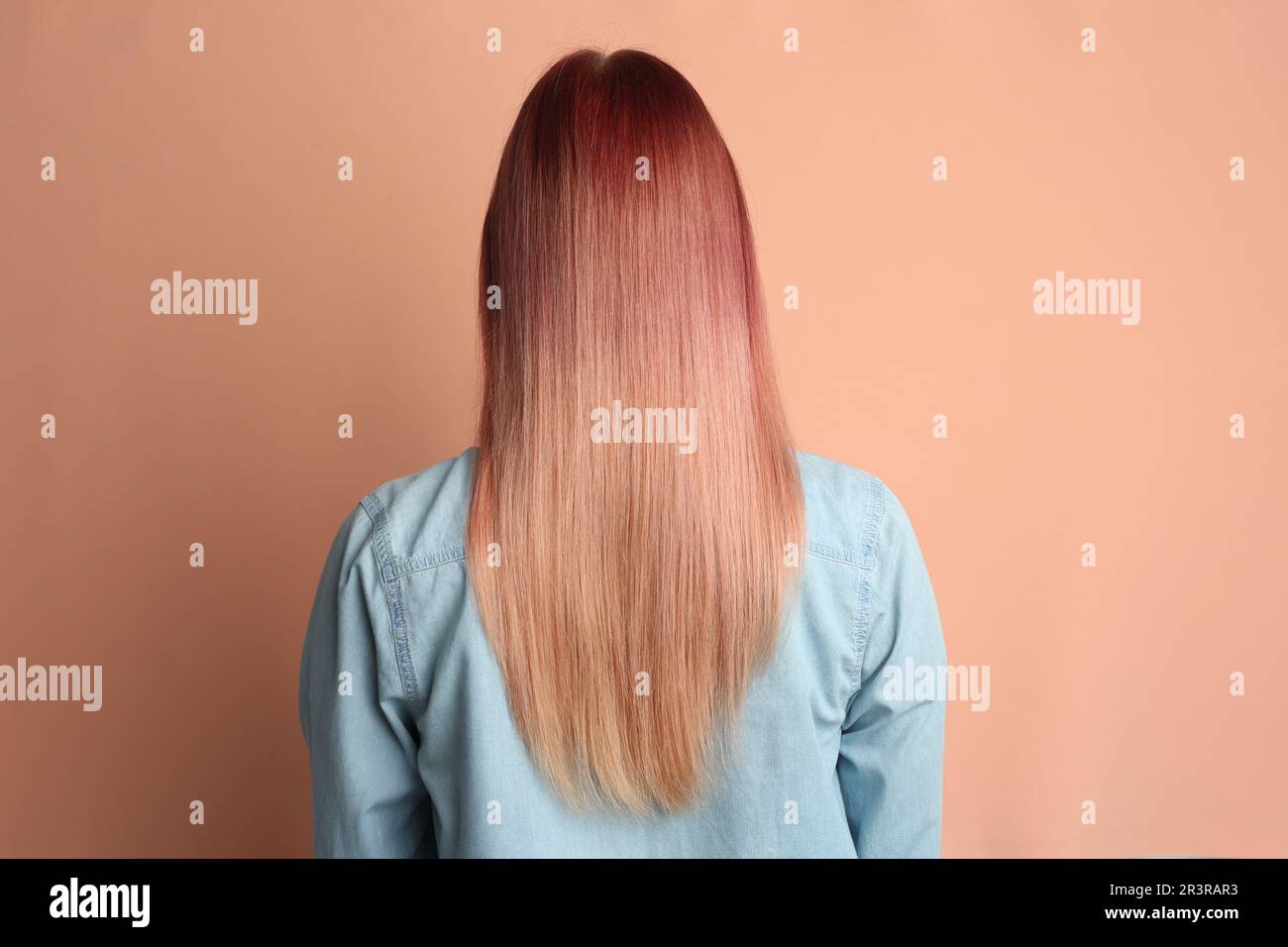 Woman with bright dyed hair on pale pink background, back view Stock ...
