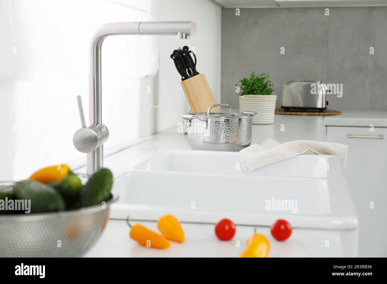 Fresh clean vegetables on kitchen counter near sink Stock Photo - Alamy