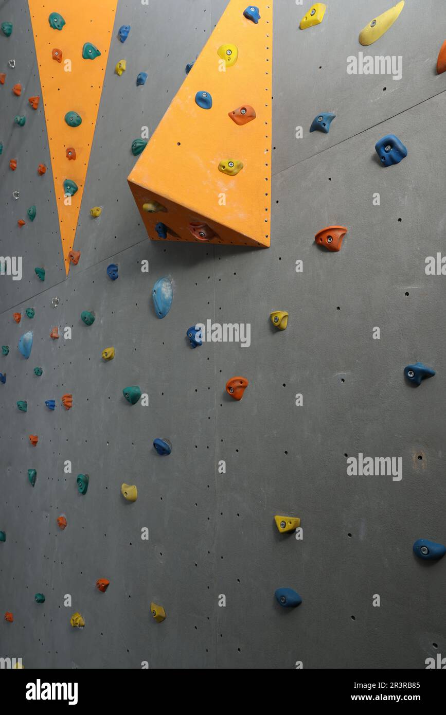 Climbing wall with holds in gym. Extreme sport Stock Photo - Alamy
