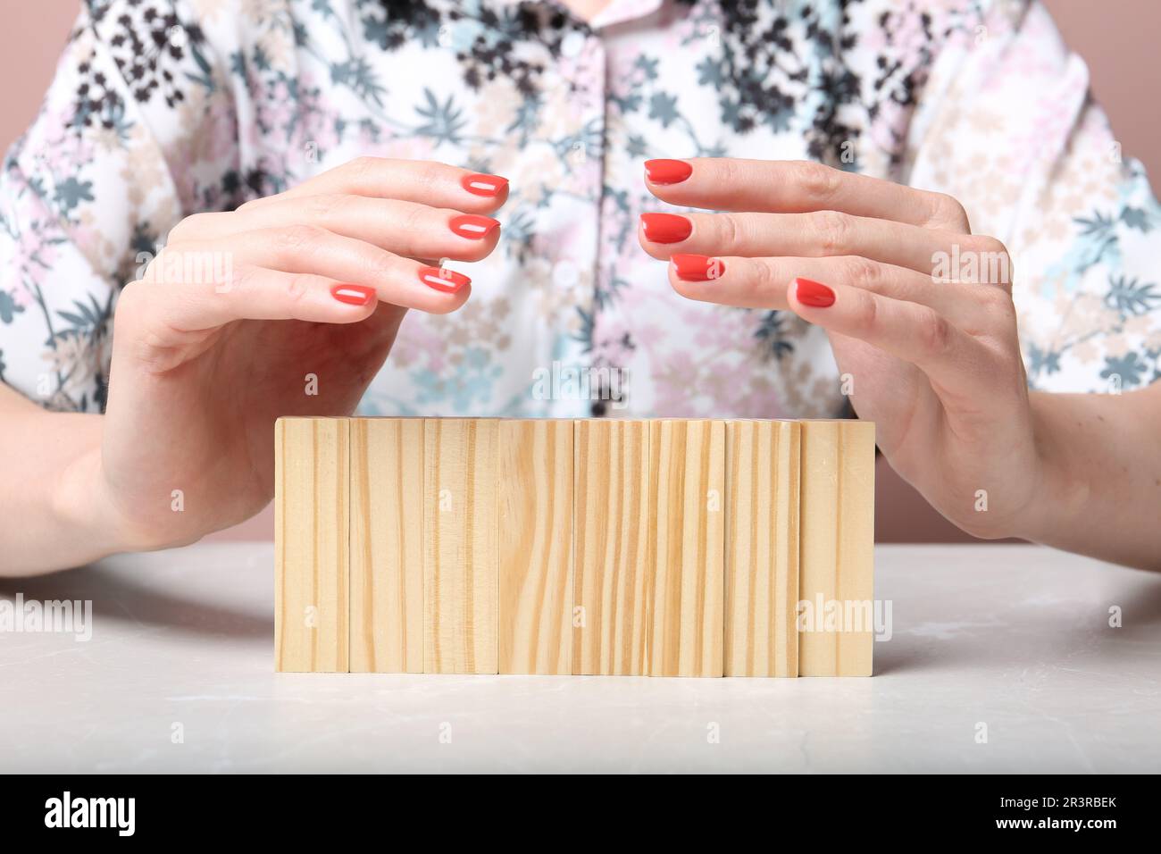 Woman demonstrating empty blocks at grey marble table, closeup. Space ...