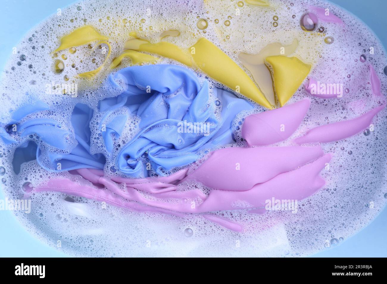 Color clothing in suds, top view. Hand washing laundry Stock Photo - Alamy