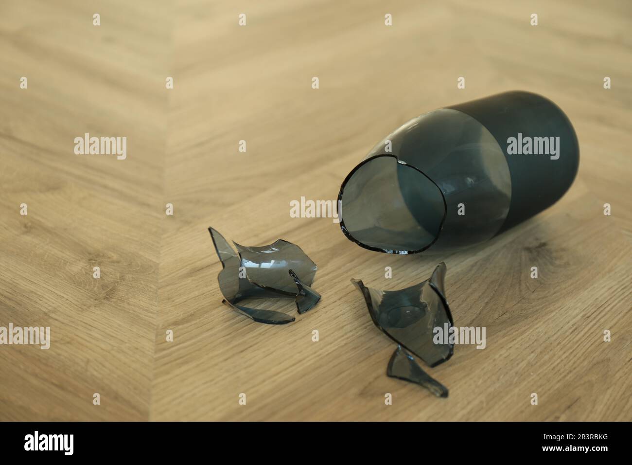 Broken blue glass vase on wooden floor. Space for text Stock Photo - Alamy