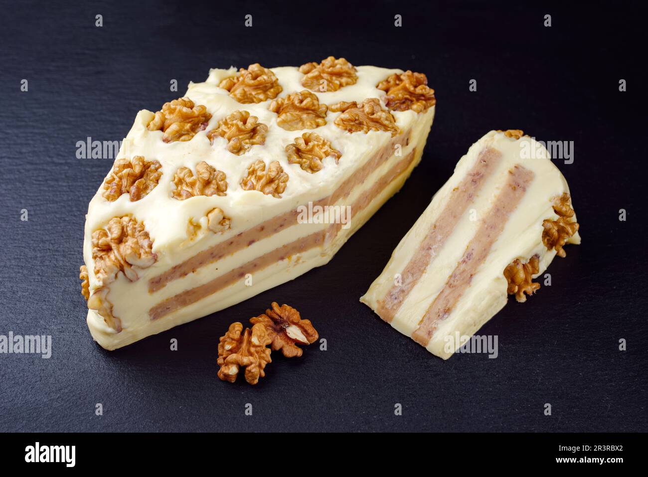 Traditional French soft cheese with walnuts offered as close-up on a ...