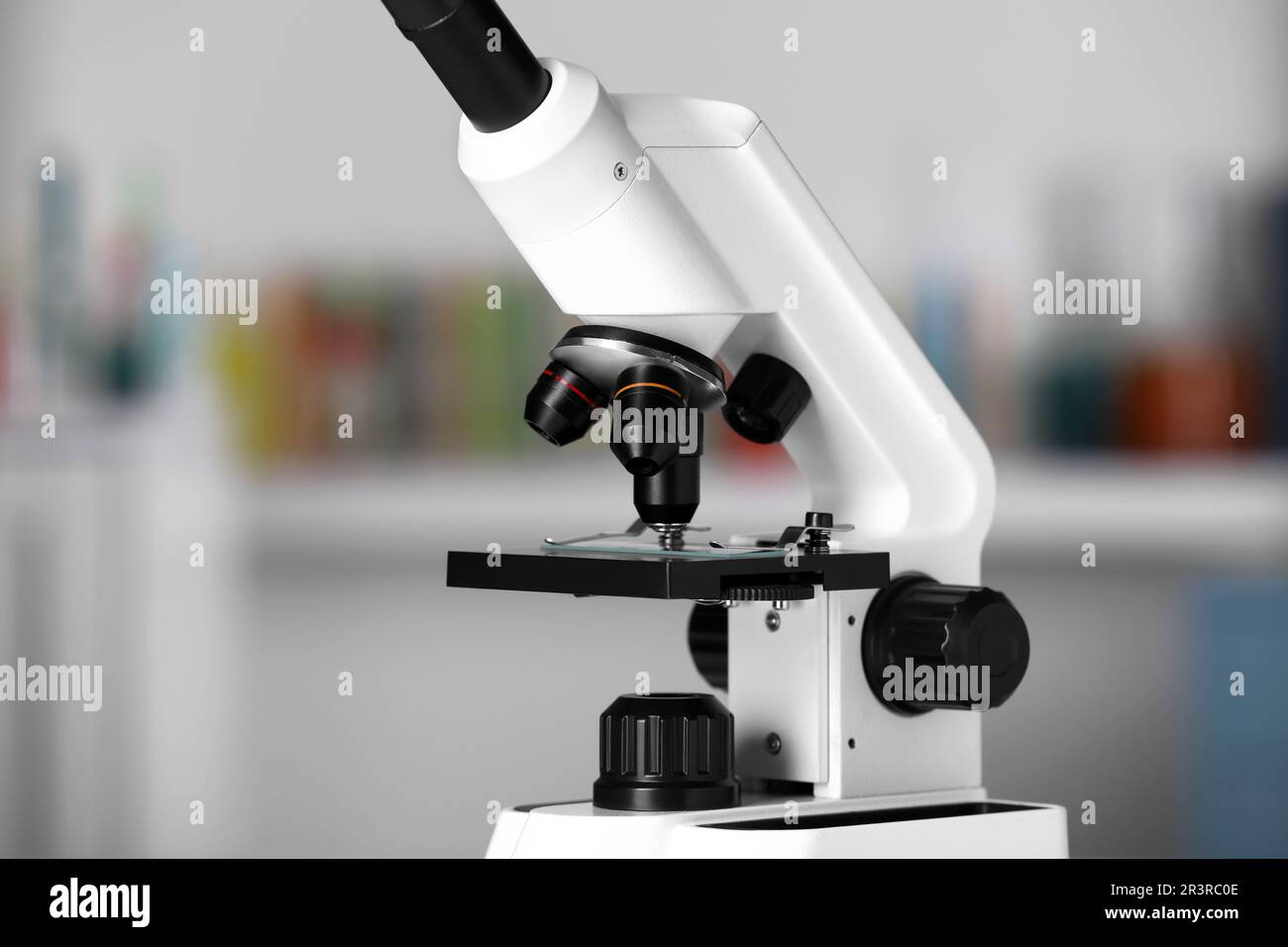 Modern medical microscope with glass slide on blurred background ...