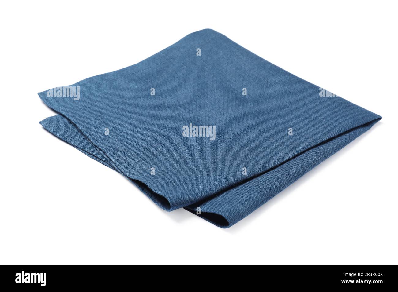 Blue folded fabric napkin on white background Stock Photo - Alamy