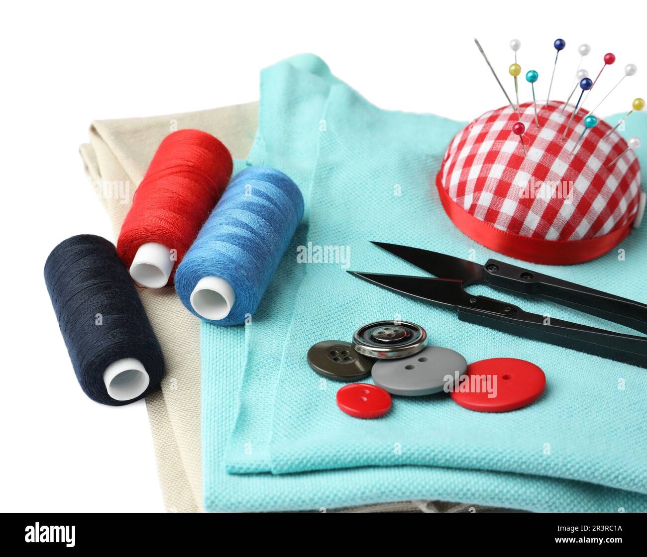 Spools of threads and sewing tools on white background Stock Photo - Alamy
