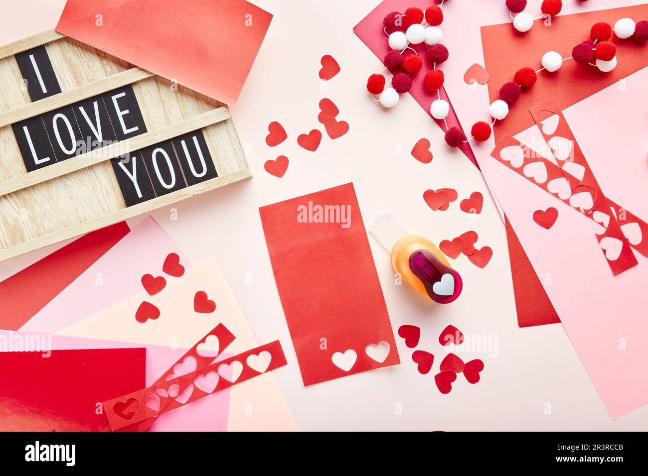 Valentines day background. Paper hearts, colored paper, paper cutter ...