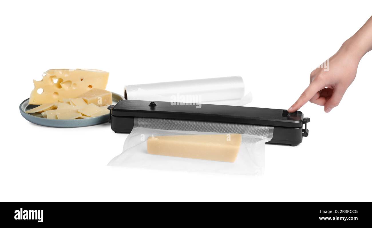 Woman packing cheese using vacuum sealer on white background, closeup ...