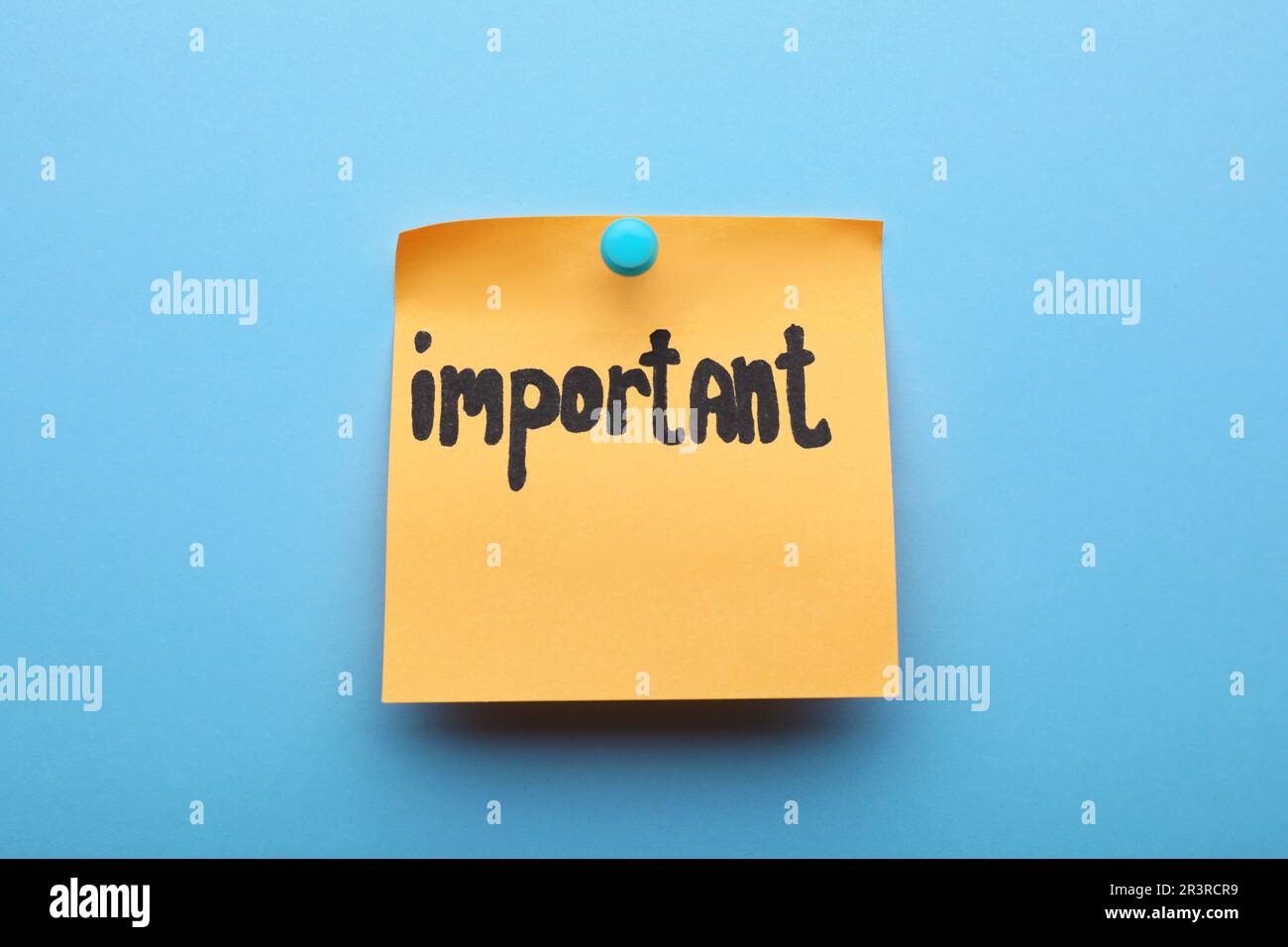 Paper note with word Important pinned on light blue background Stock ...