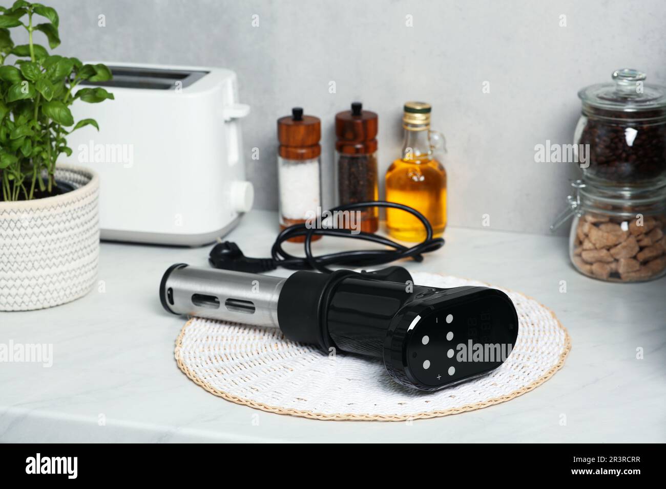 Thermal immersion circulator on table in kitchen. Sous vide cooking ...