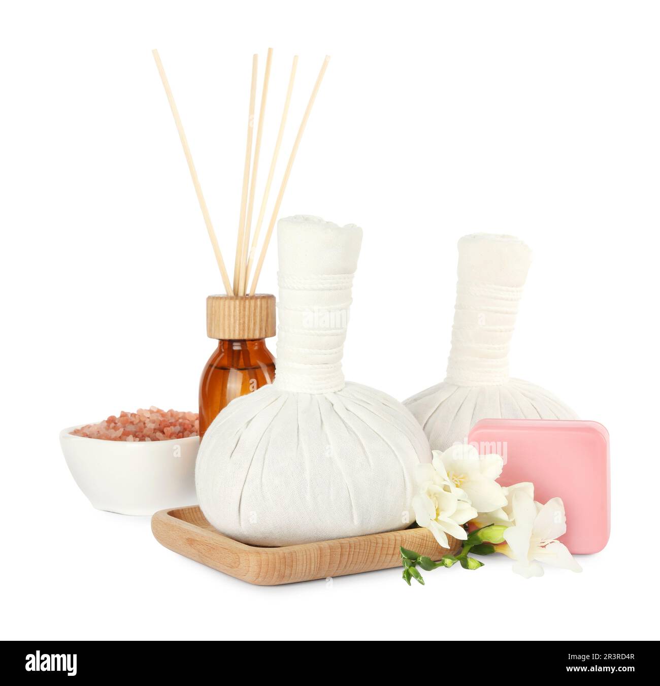 Herbal massage bags, soap, flowers, air reed diffuser and sea salt on ...