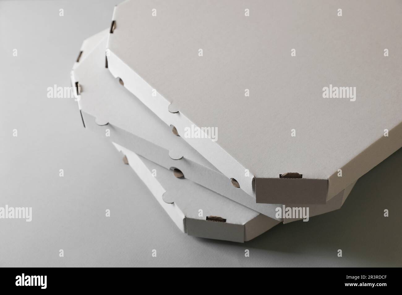 Stack of empty pizza boxes on grey background, closeup Stock Photo - Alamy