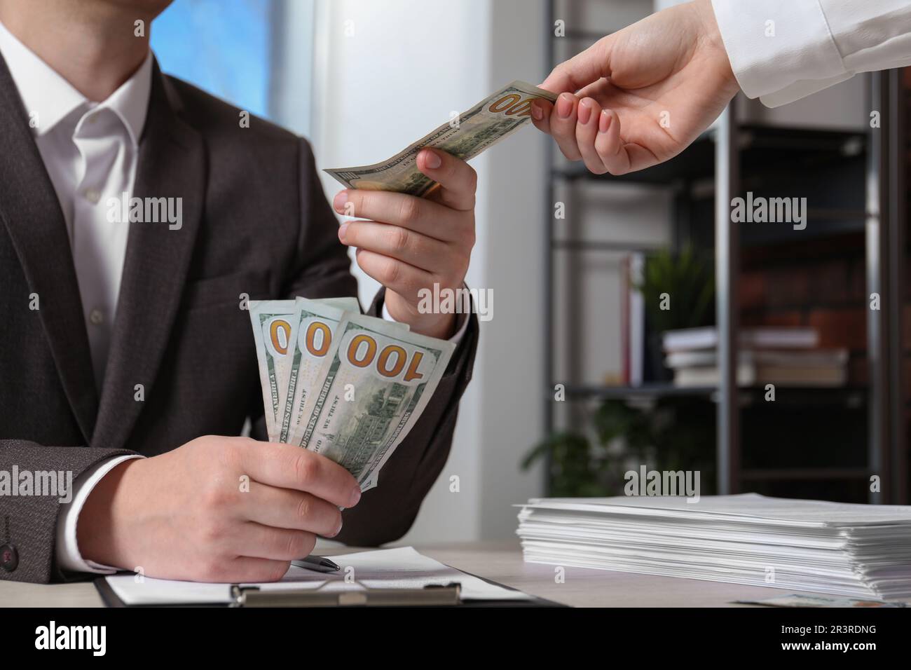 Man giving money to woman indoors, closeup. Currency exchange Stock ...