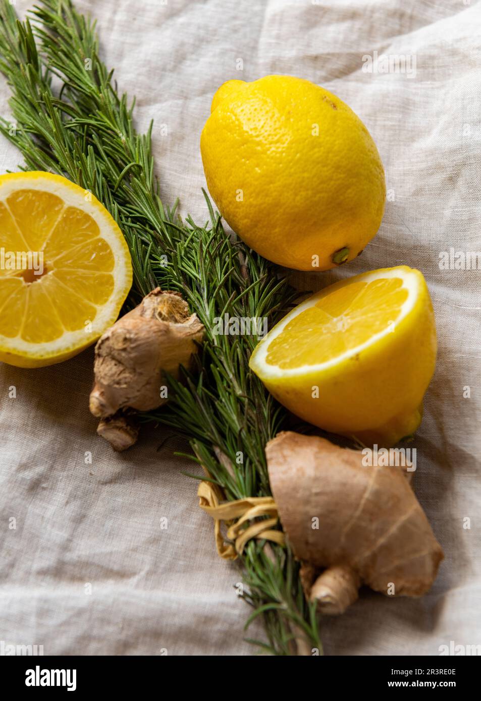 Fresh rosemary bunch ginger and lemon on a natural linen cloth Stock ...