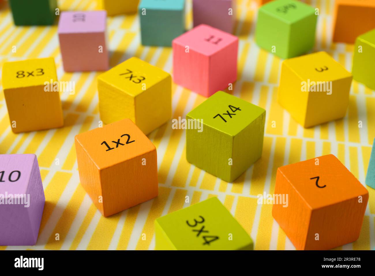 Colorful cubes with numbers and multiplications on yellow background ...
