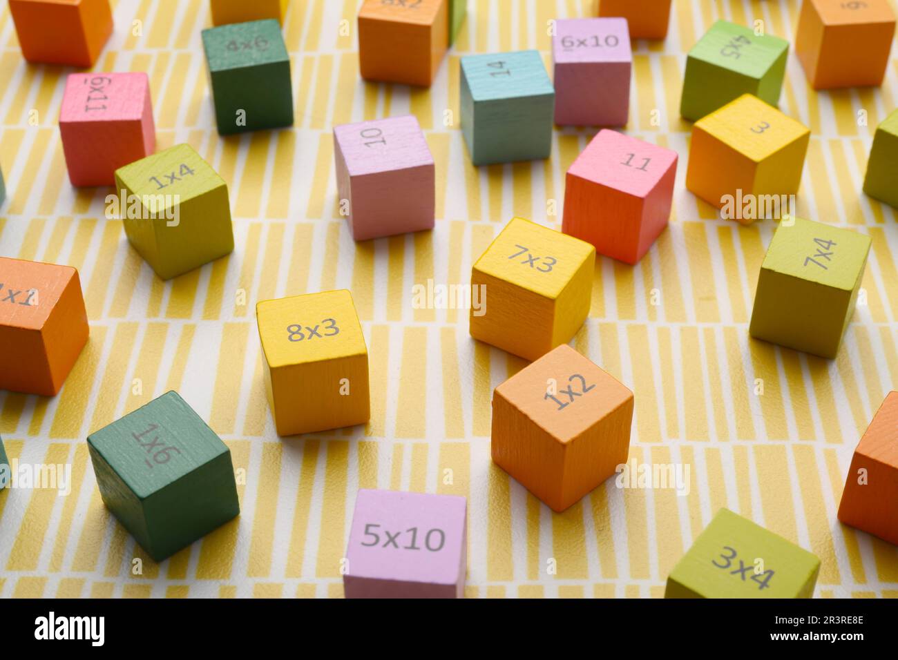 Colorful cubes with numbers and multiplications on yellow background ...