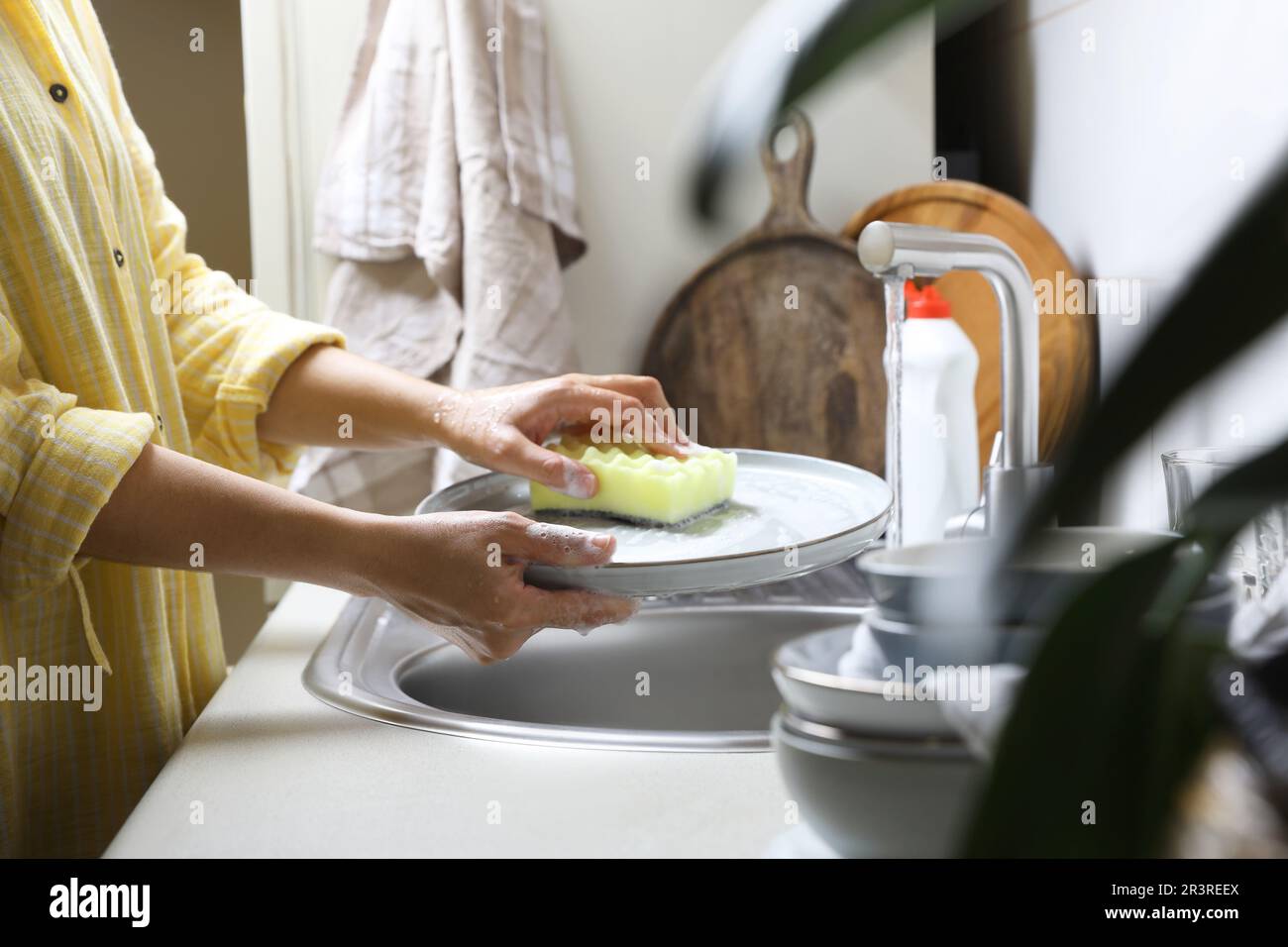 Woman washing utensil in hi-res stock photography and images - Alamy